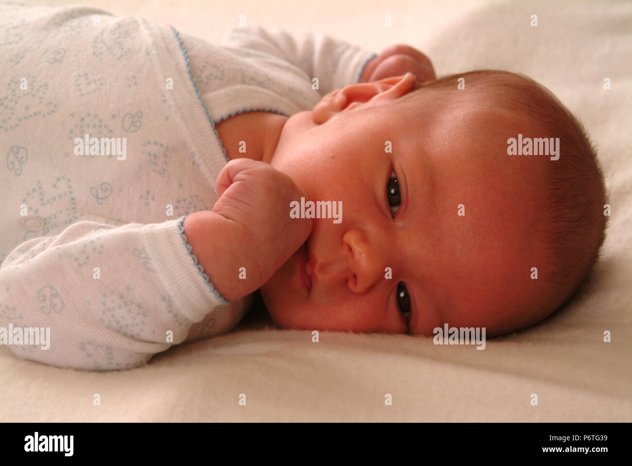 Portrait of newborn baby awake looking serene Stock Photo - Alamy