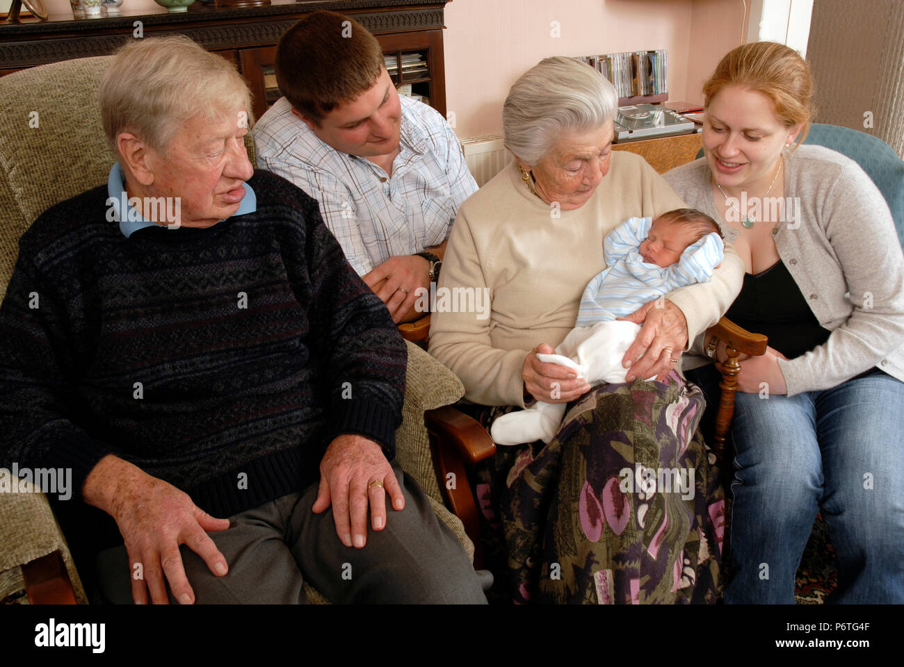Portrait of three generations, baby being held by grandmother Stock ...