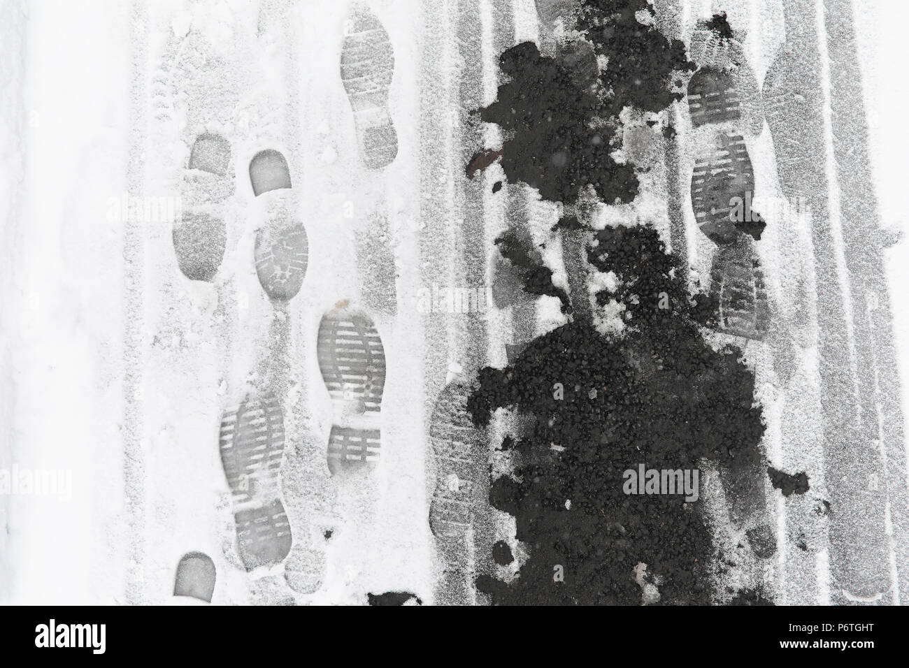 Footprints in the snow. Footprints on the first snow. Imprint of shoes ...