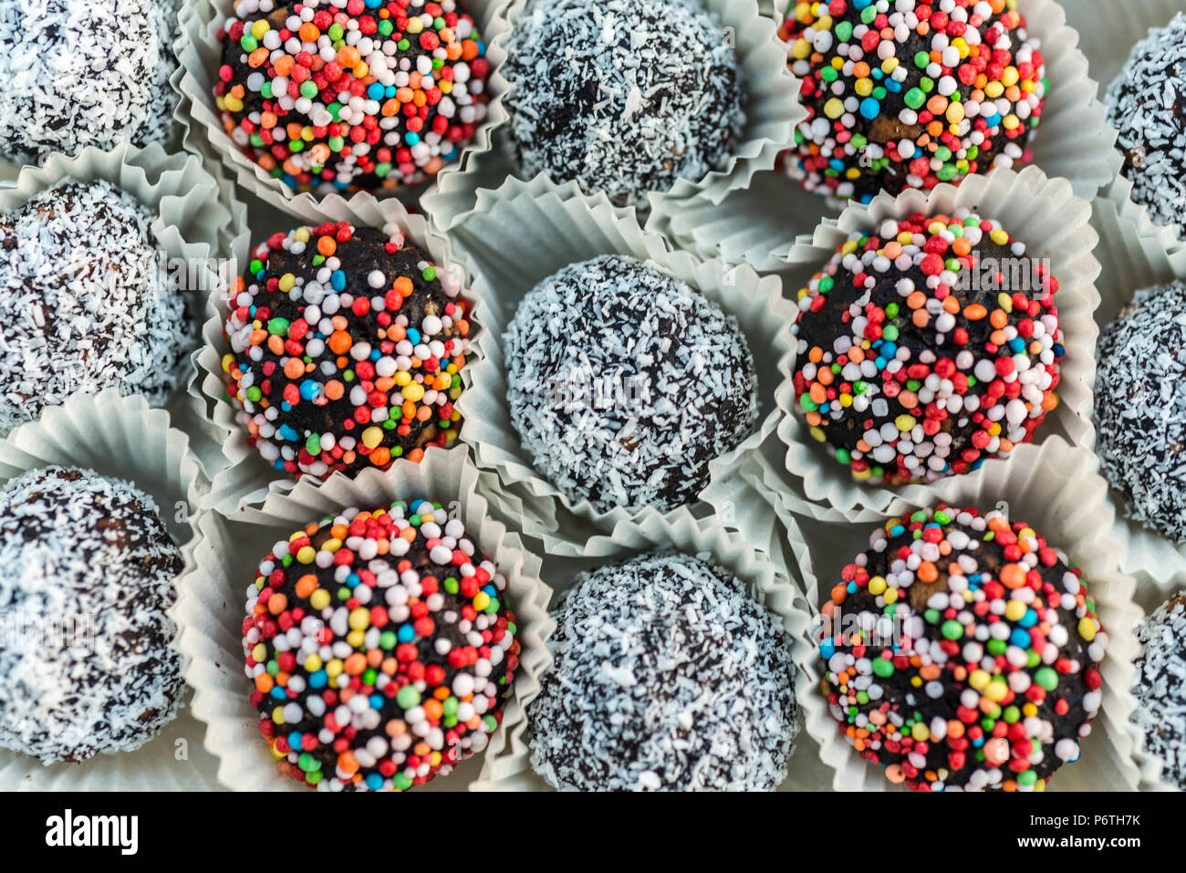 Chocolate ball with coconut and colorful topping Stock Photo - Alamy