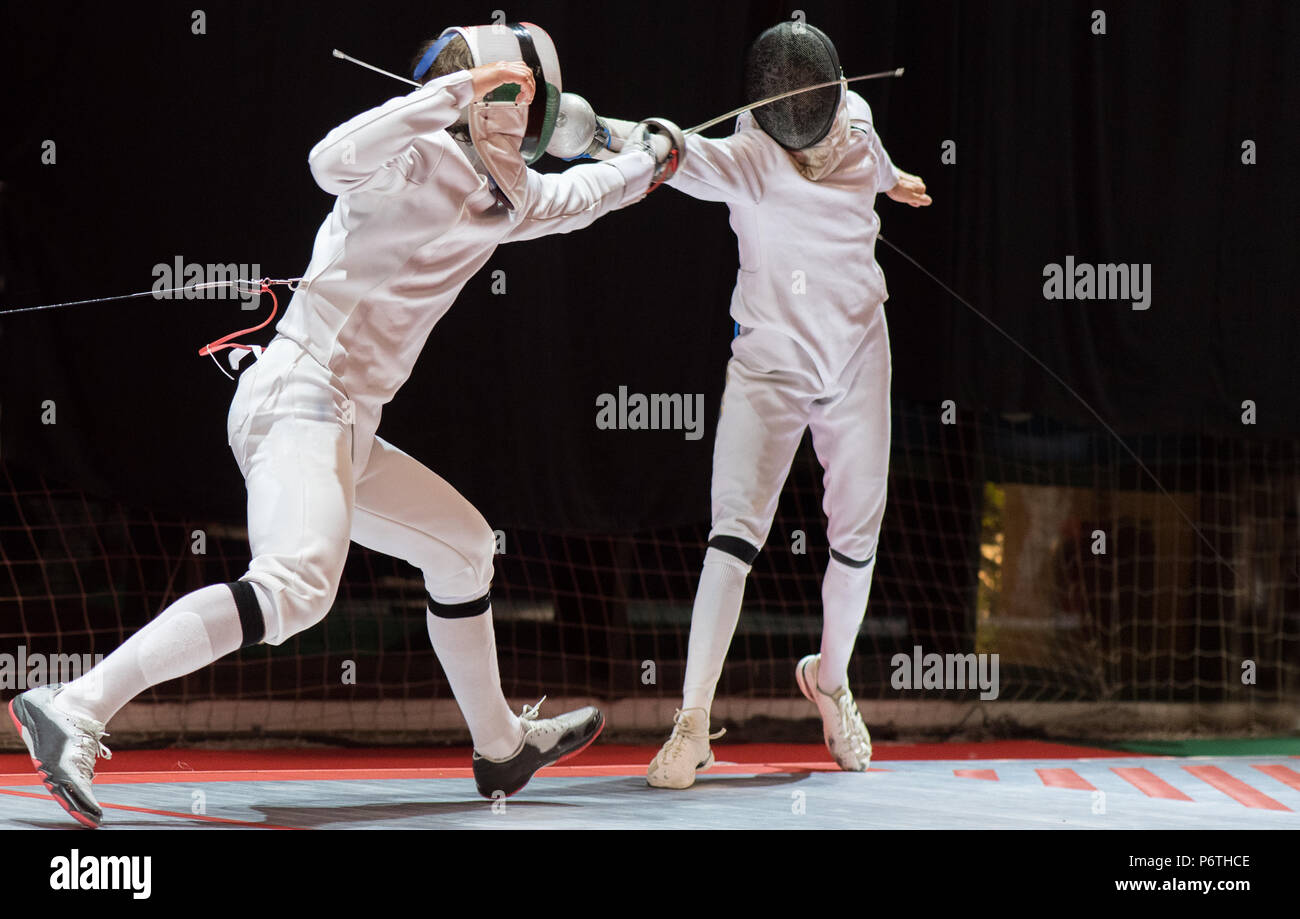 Two man fencing athletes fight on professional sports arena Stock Photo ...