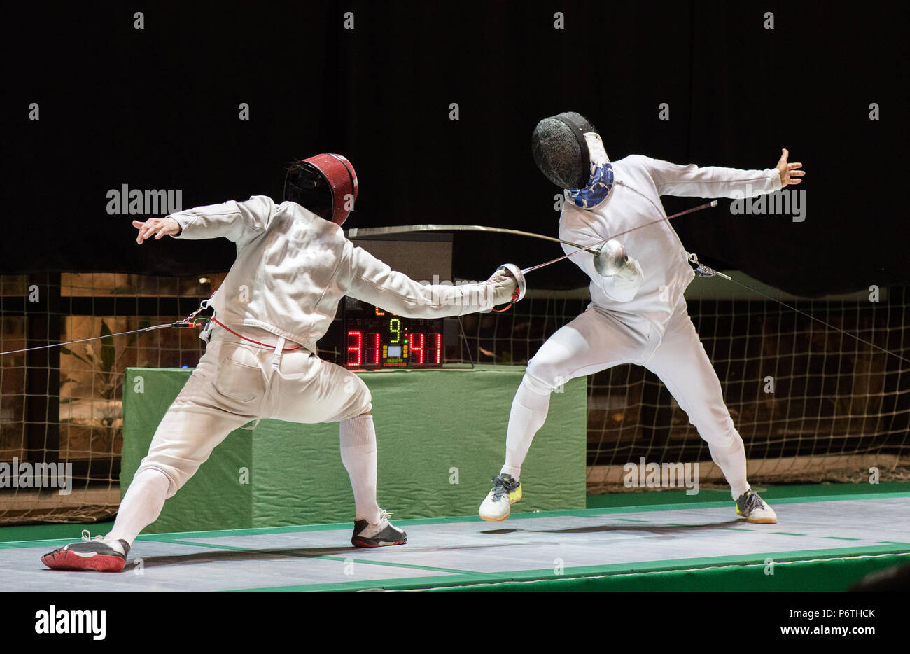 Two man fencing athletes fight on professional sports arena Stock Photo ...