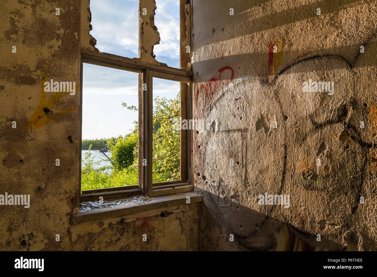 Inside of abandoned and vandalized building with broken window with ...