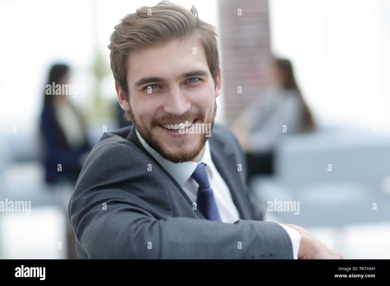 Successful business man standing with his staff in background at Stock ...