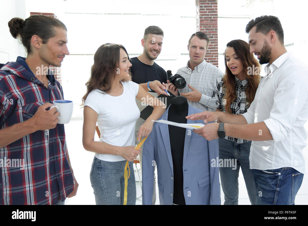 designers working with new models of men's clothing Stock Photo - Alamy