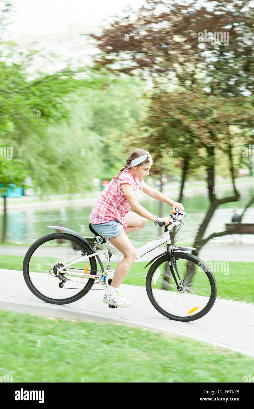 Girl riding her bicycle Stock Photo - Alamy
