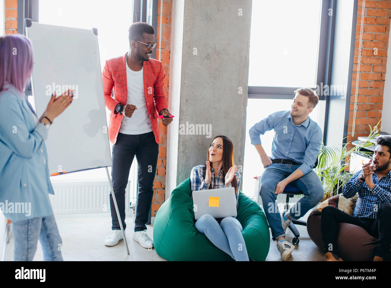 Young people of different races and nationalities having team building ...