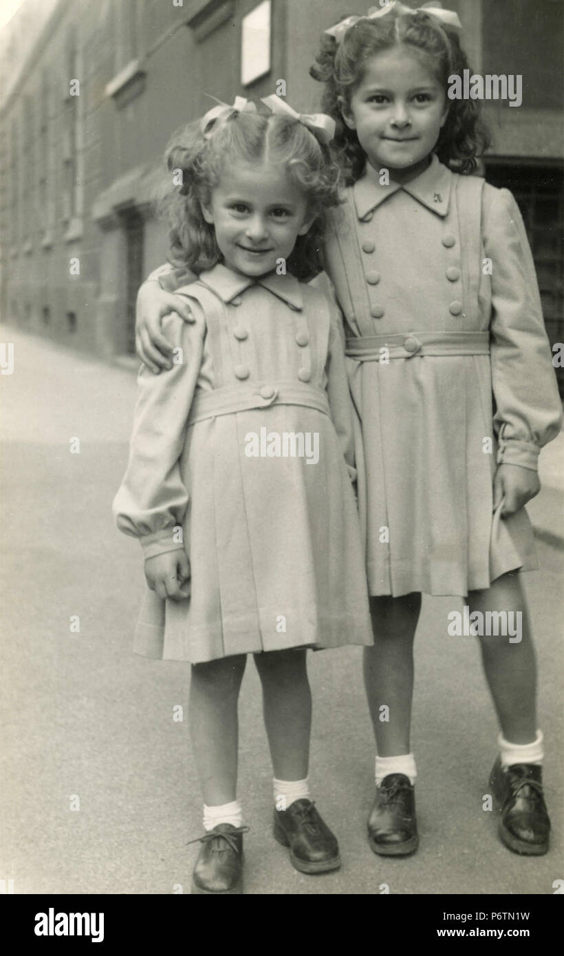 Two little sisters dressed alike, Italy 1940s Stock Photo - Alamy