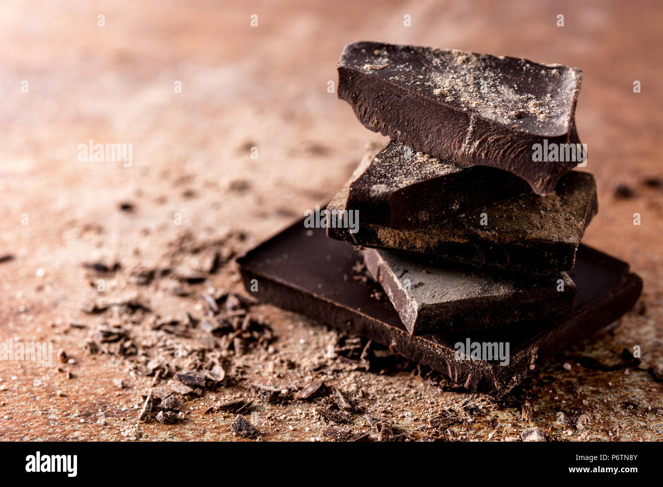 Broken chocolate pieces on brown background. Copyspace Stock Photo - Alamy