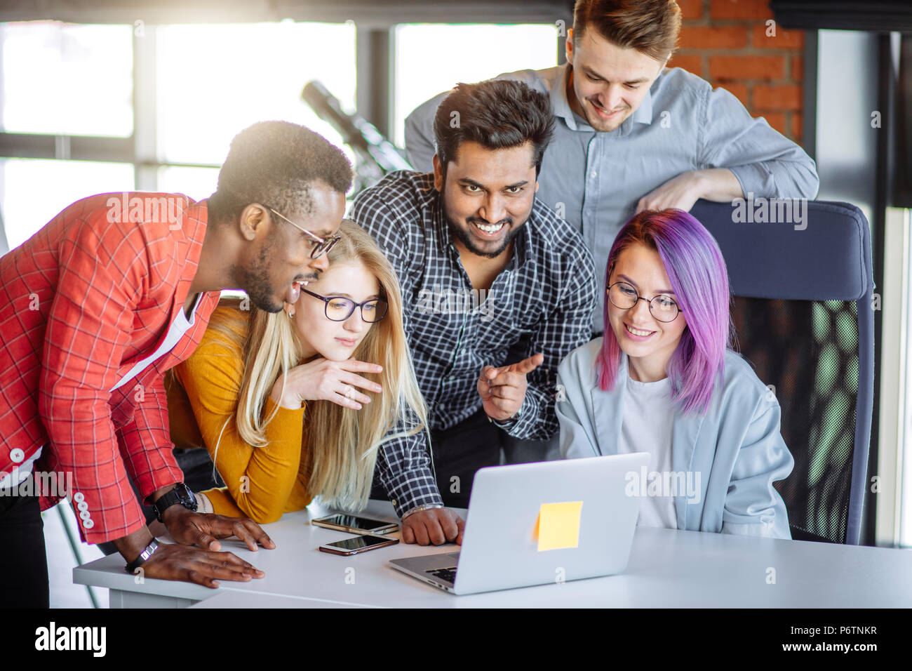Group young students around laptop hi-res stock photography and images ...