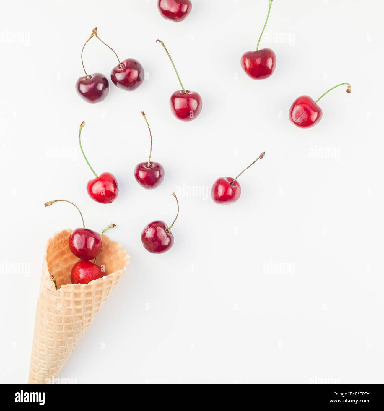 Square Creative top view of ripe cherries in a waffle cone with copy ...