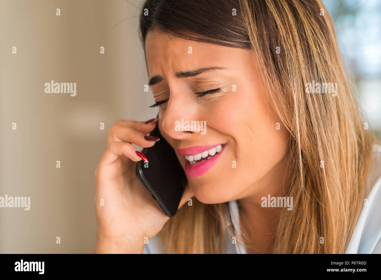 Sad woman talking on the smartphone, depressed and crying. Breaking off ...
