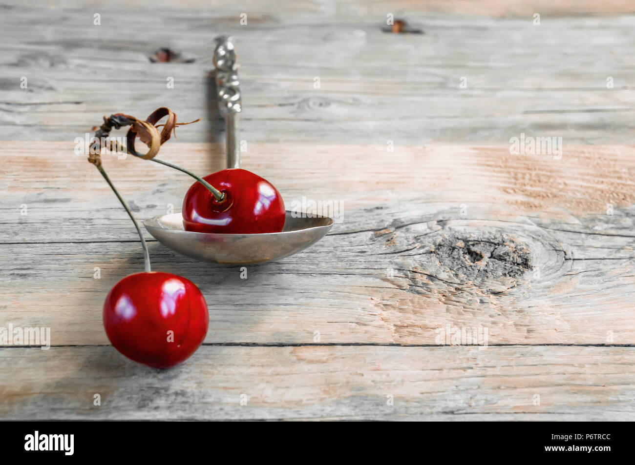 Fresh ripe cherries in spoon on wooden background. Copy space Stock ...