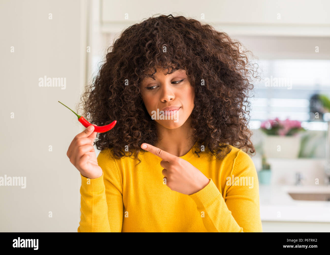 Red hot chili pepper eating woman hi-res stock photography and images ...
