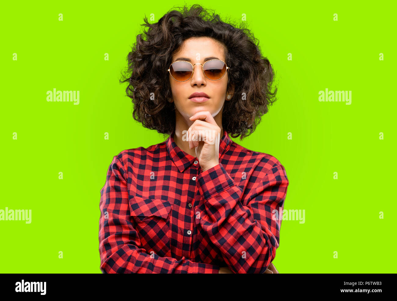 Beautiful arab woman thinking and looking up expressing doubt and ...
