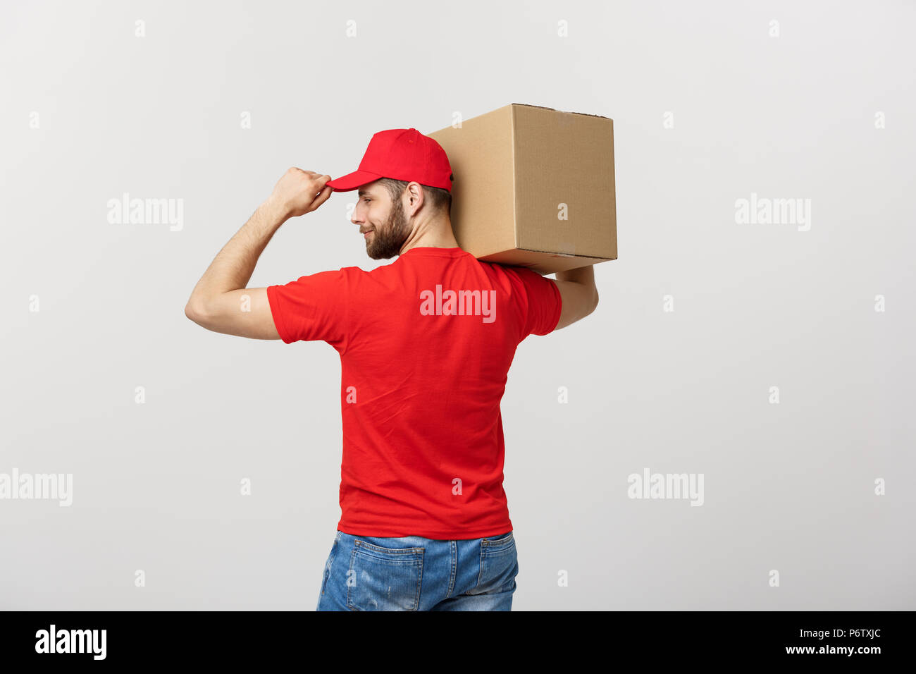 Delivery Concept - back view of Handsome Caucasian delivery man with ...