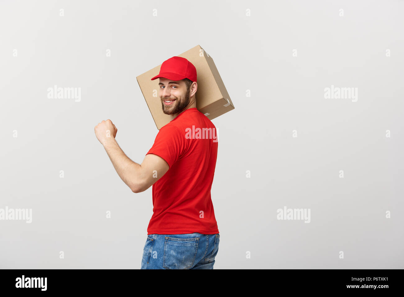 Delivery Concept - back view of Handsome Caucasian delivery man with ...
