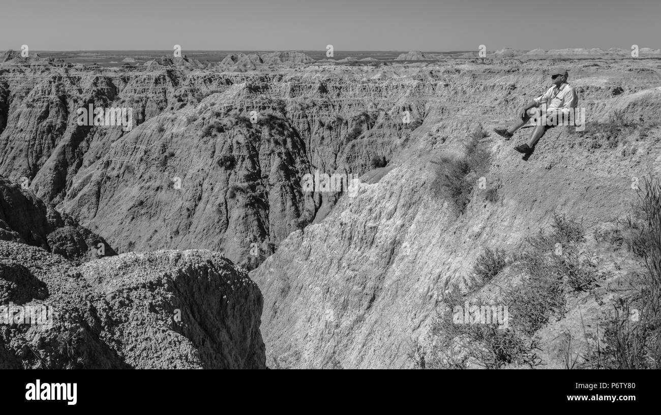 Man sitting on edge hi-res stock photography and images - Alamy