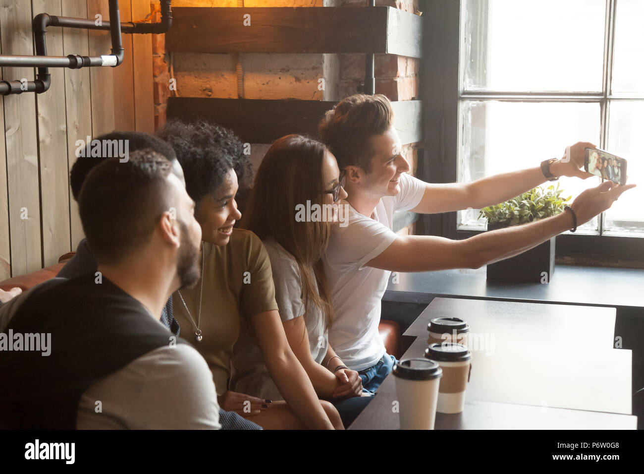 Happy multiracial friends making self-portrait during meeting in Stock ...