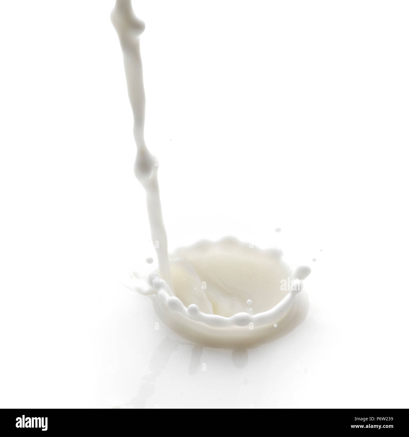 Pouring milk splash isolated on white background macro Stock Photo - Alamy