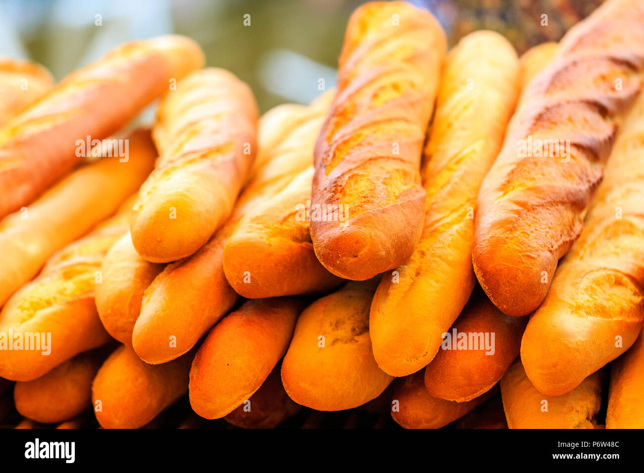 French bread, French sticks, baquettes, freshly baked, stacked two to ...