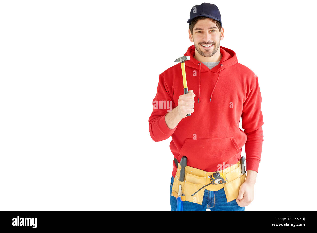 Portrait of happy young repairman holding a hammer in his hand ...