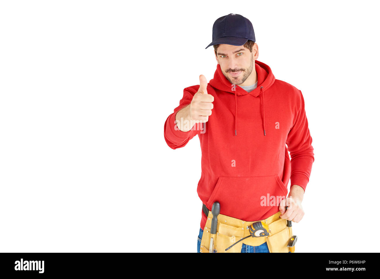 Portrait of happy young man wearing baseball cap with hoodie while ...