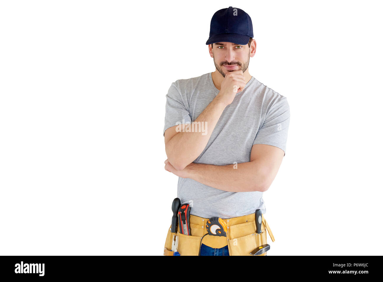 Portrait of handyman with hand on his standing at isolated white ...