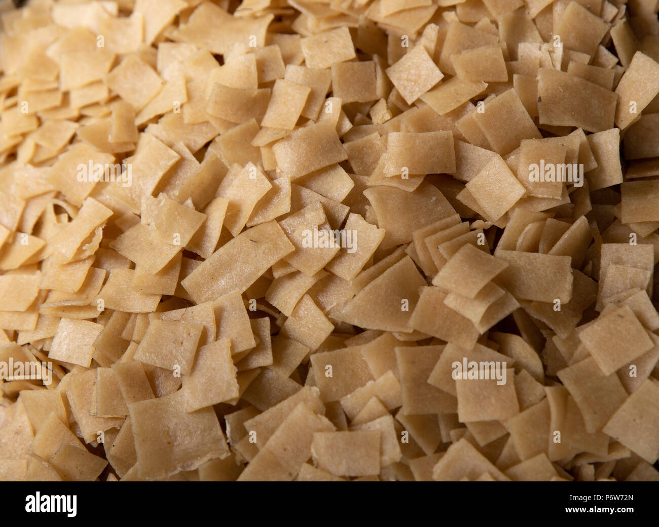 Square uncooked noodles for asian dishes Stock Photo - Alamy