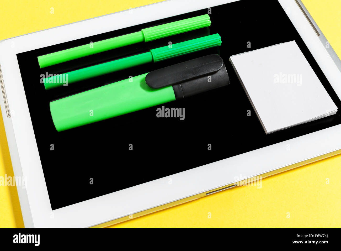 stationary lying on the switched off screen of a tablet pc Stock Photo ...