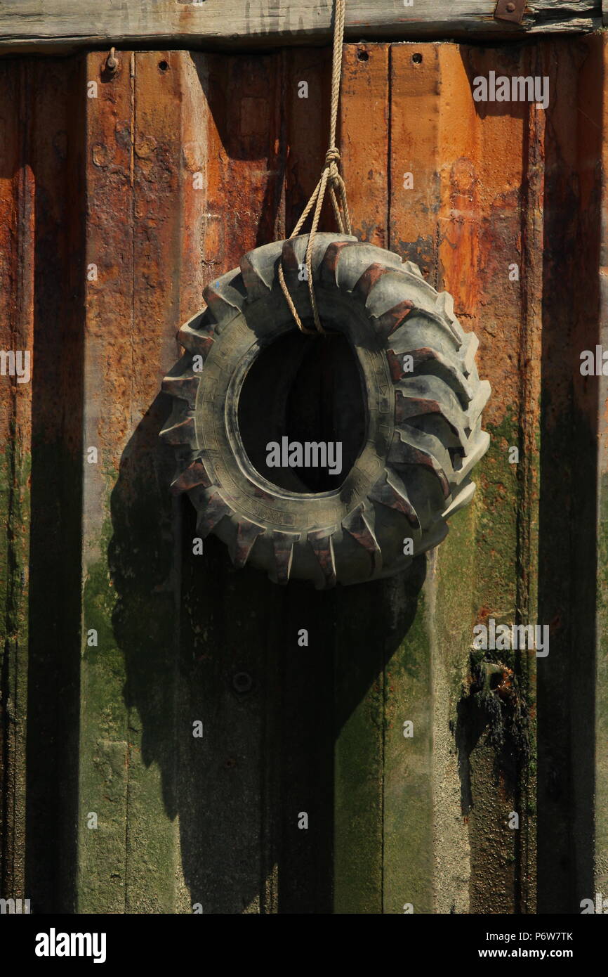 Coastal landscapes - Transport industry - rubber tyre suspended from ...