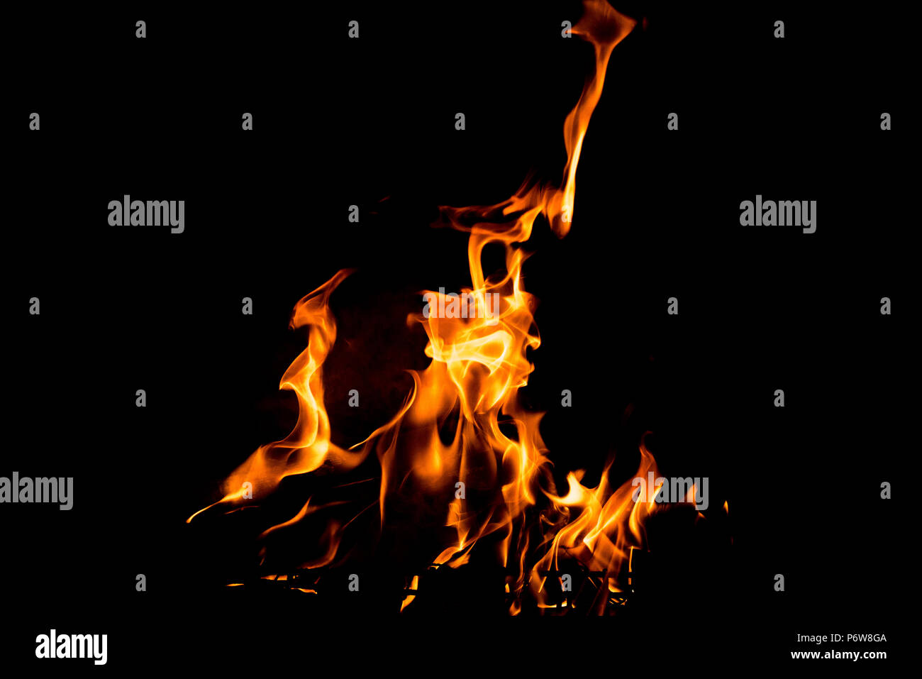 Flames in the fire of a red and yellow barbecue Stock Photo - Alamy