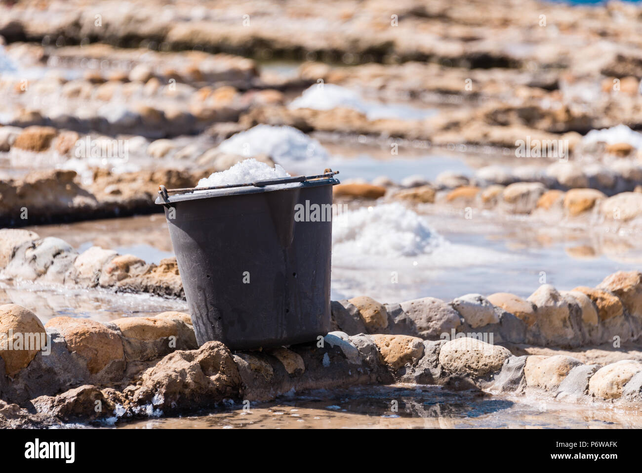 Harvesting sea salt from the ancient salt pans in Marsalforn, Gozo ...