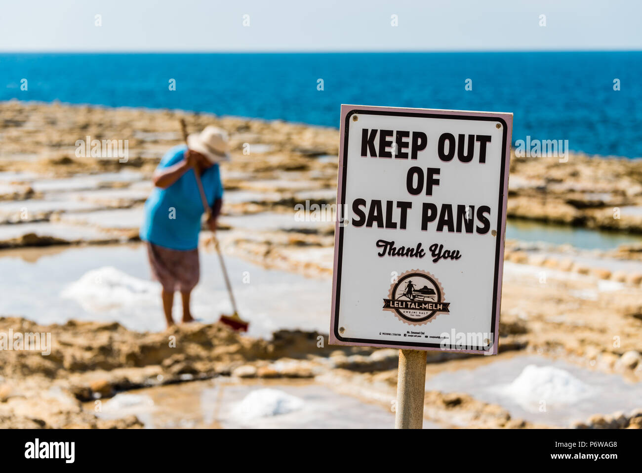 Harvesting sea salt from the ancient salt pans in Marsalforn, Gozo ...