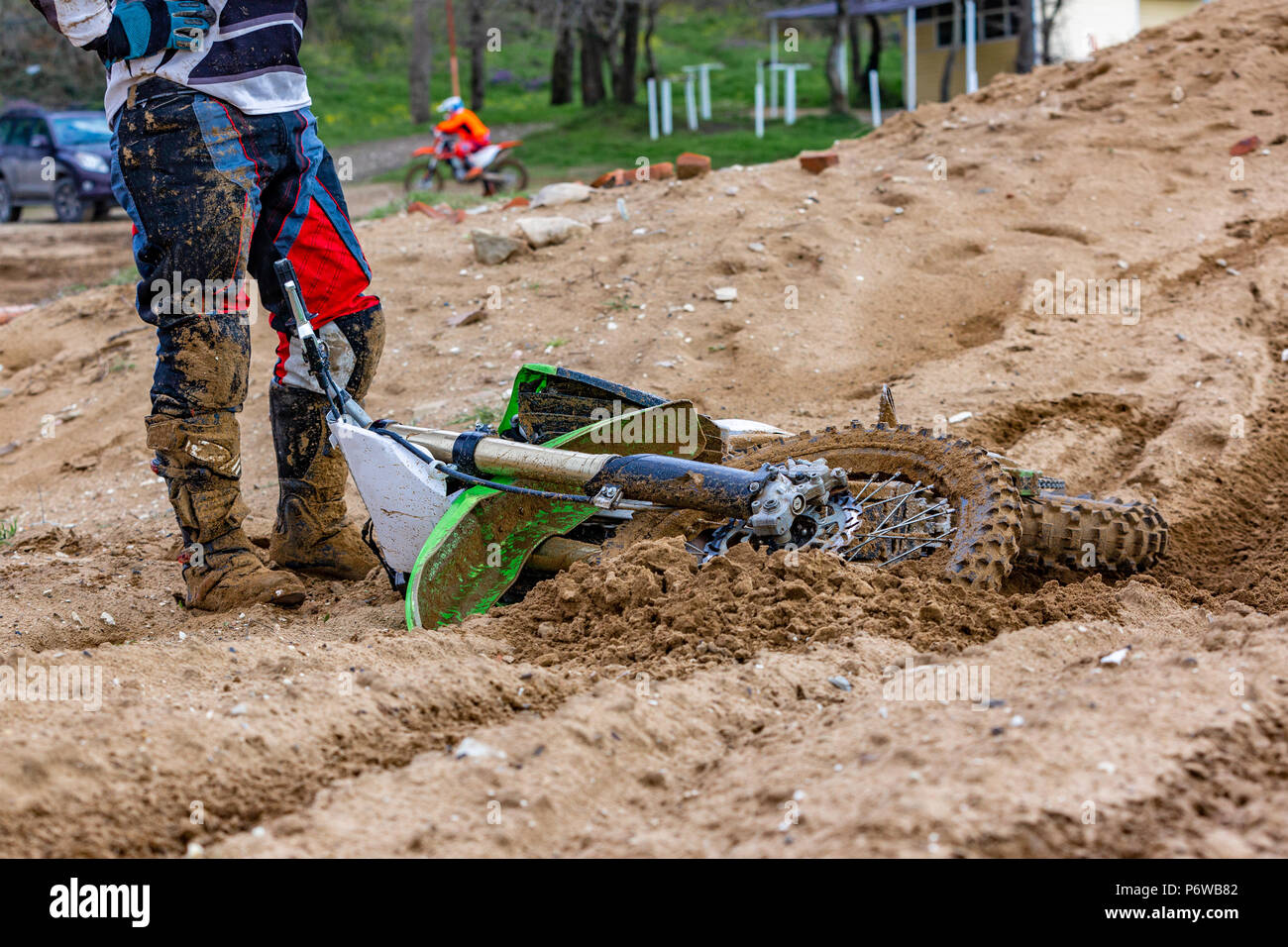 Close-up of accident in mountain bikes race in dirt track with flying ...