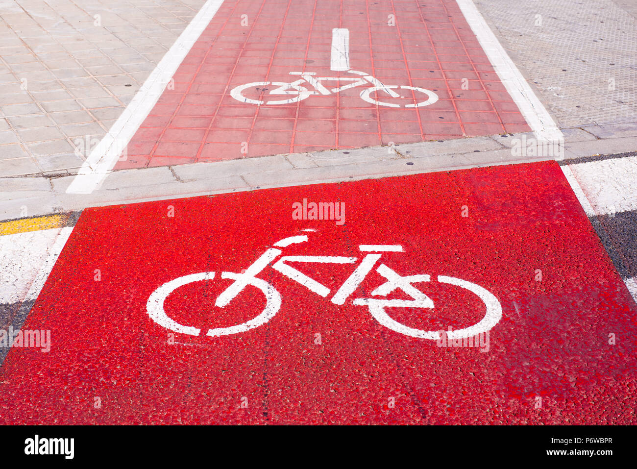 Signs and bike lane markings painted on the asphalt of the streets of ...