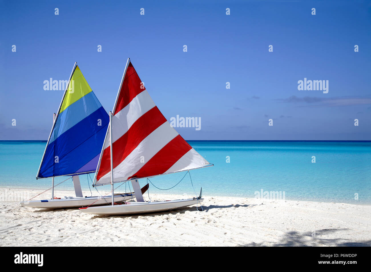 Two lateen rigged sailboats lie on the beach waiting for a sailor Stock ...