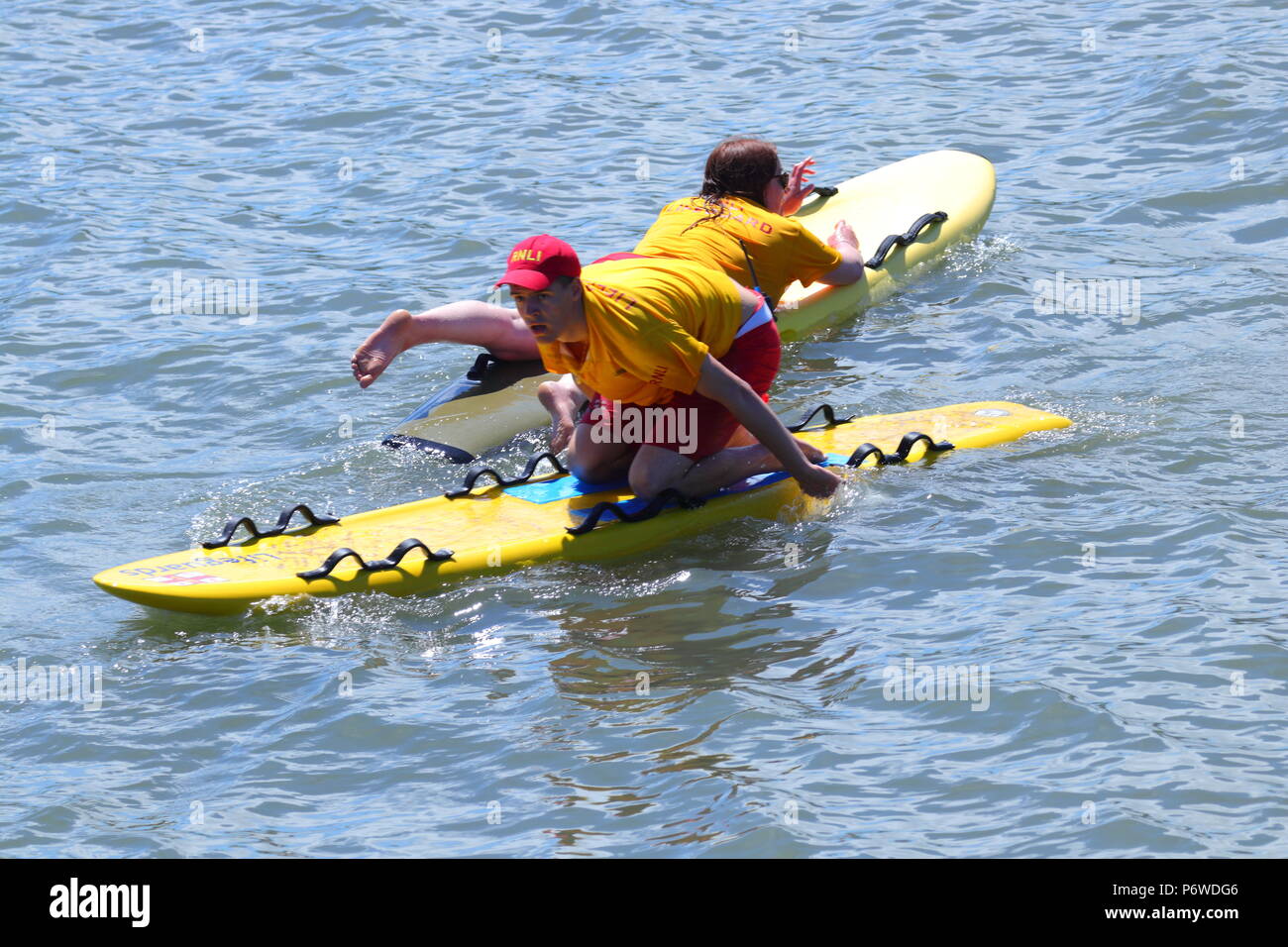 An RNLI Lifeguard in Scarborough races to a man that is swimming in a ...