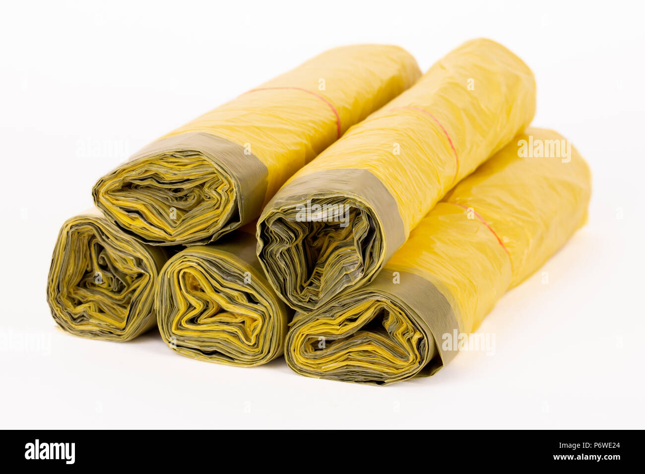 Rolls of yellow plastic trash back to recycle on white background Stock ...