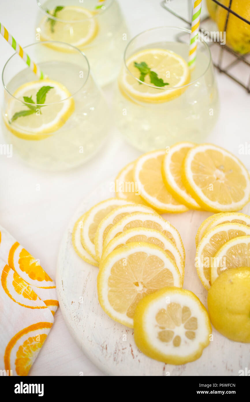Fresh sliced lemon on a white wood cutting board Stock Photo - Alamy