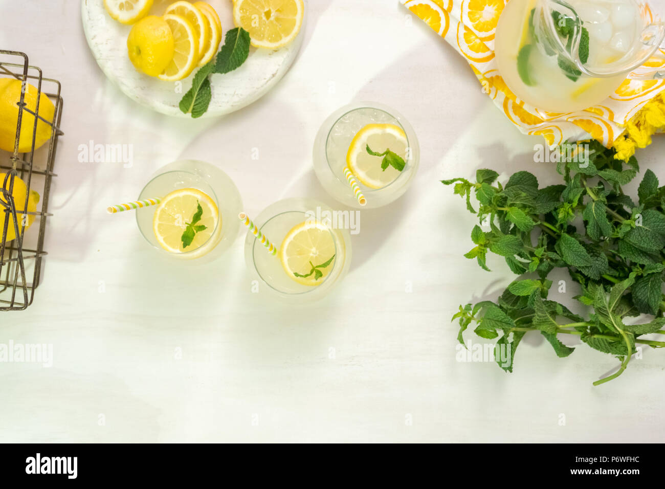 Fresh lemonade in a drinking glasses garnished with sliced of lemon and ...