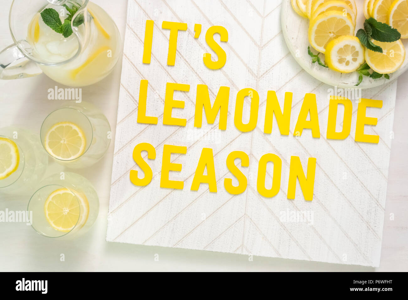 It's lemonade season wood sign with freshly sliced lemons on a wood ...
