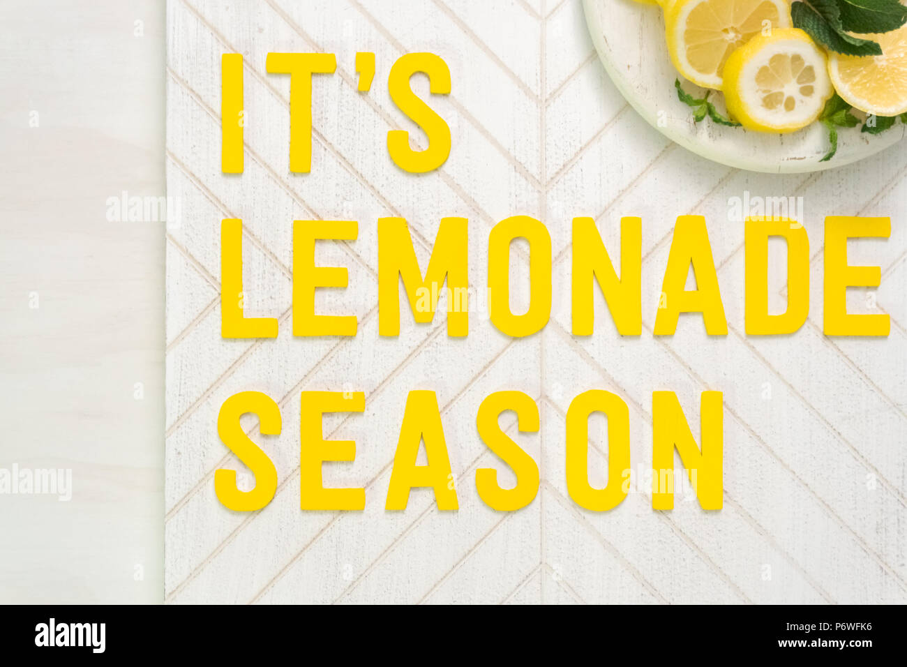 It's lemonade season wood sign with freshly sliced lemons on a wood ...