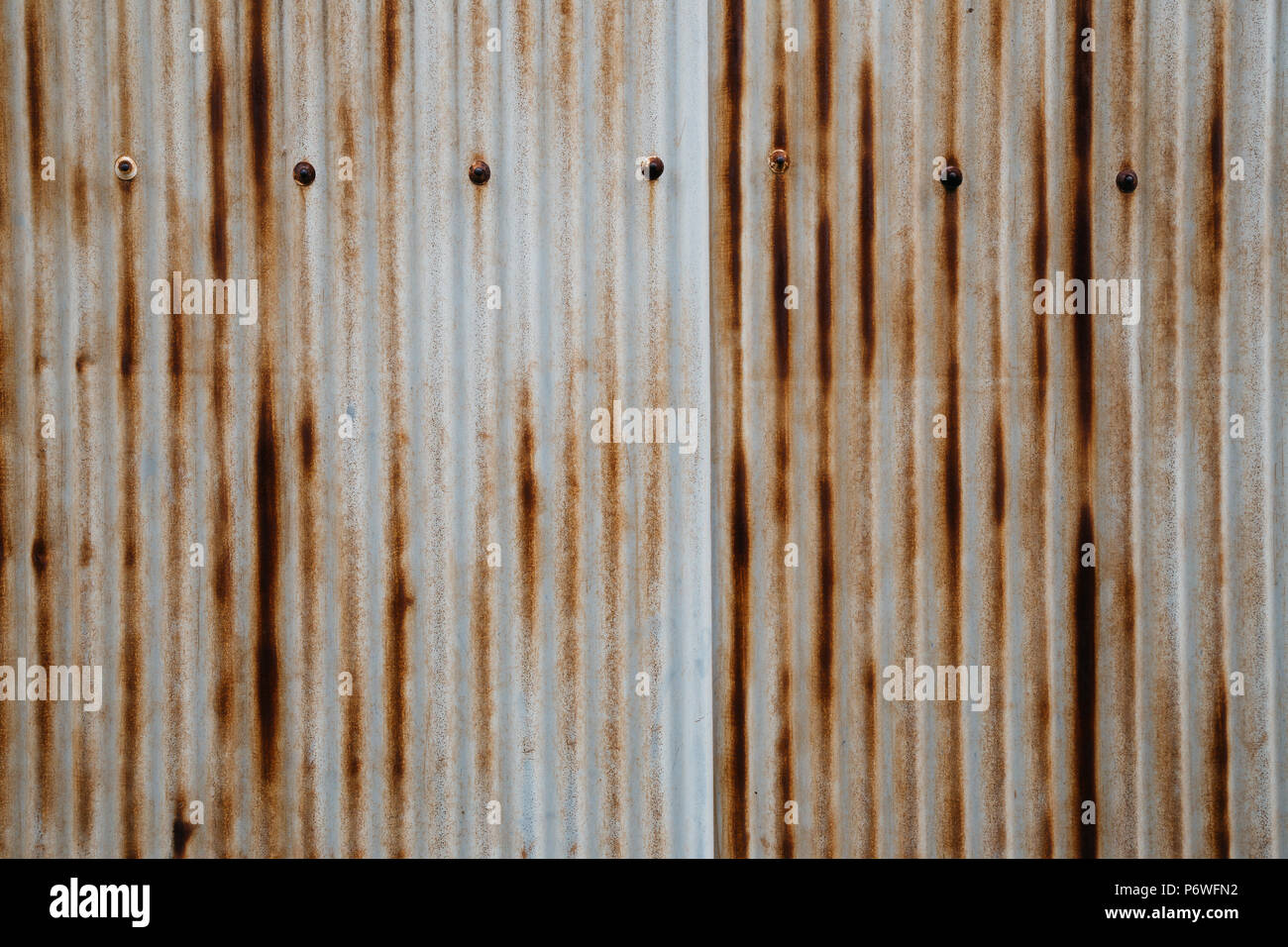 Old rusty wavy metal plate wall background Stock Photo - Alamy