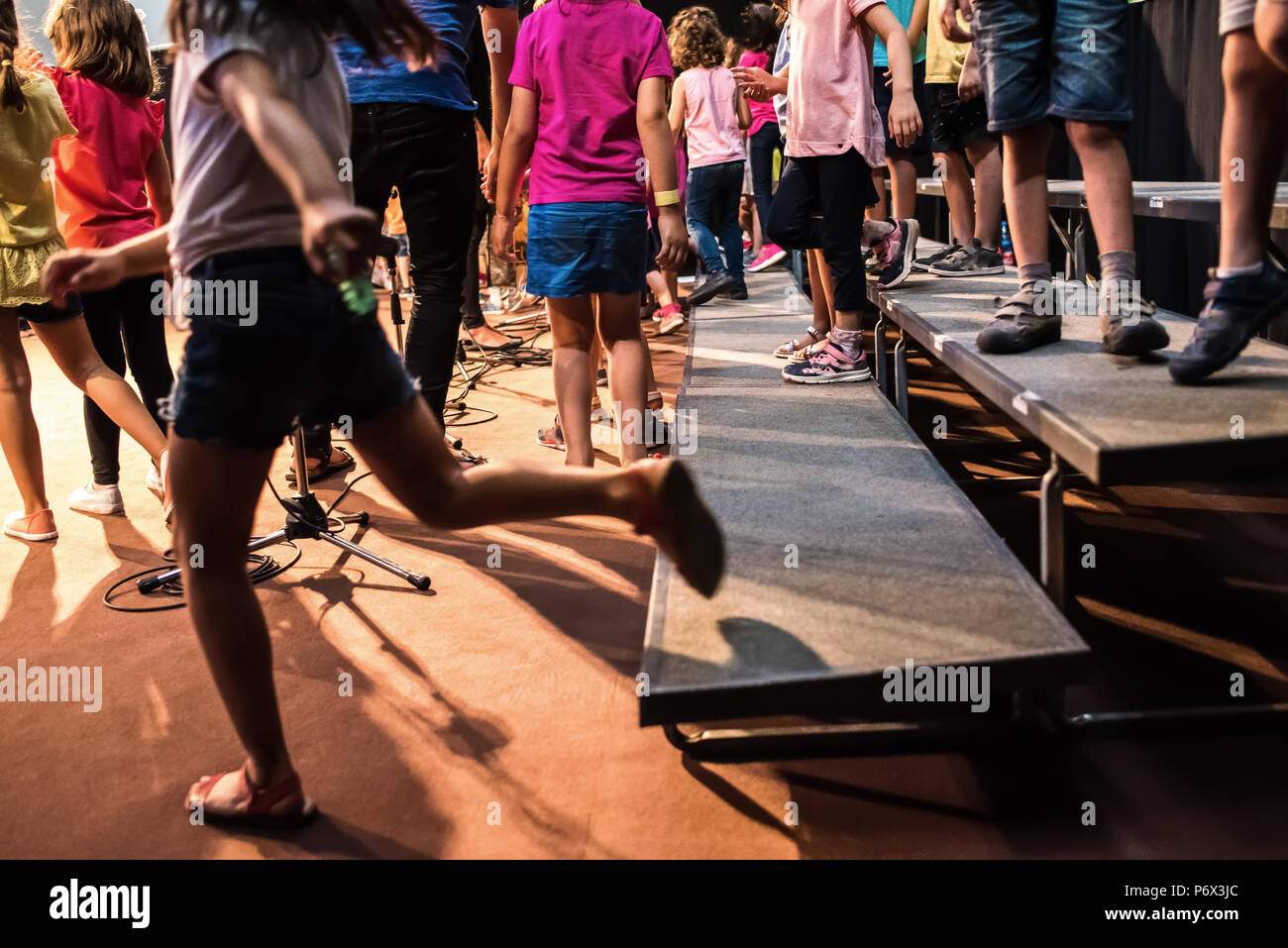 Group of children coming down from a stage Stock Photo - Alamy