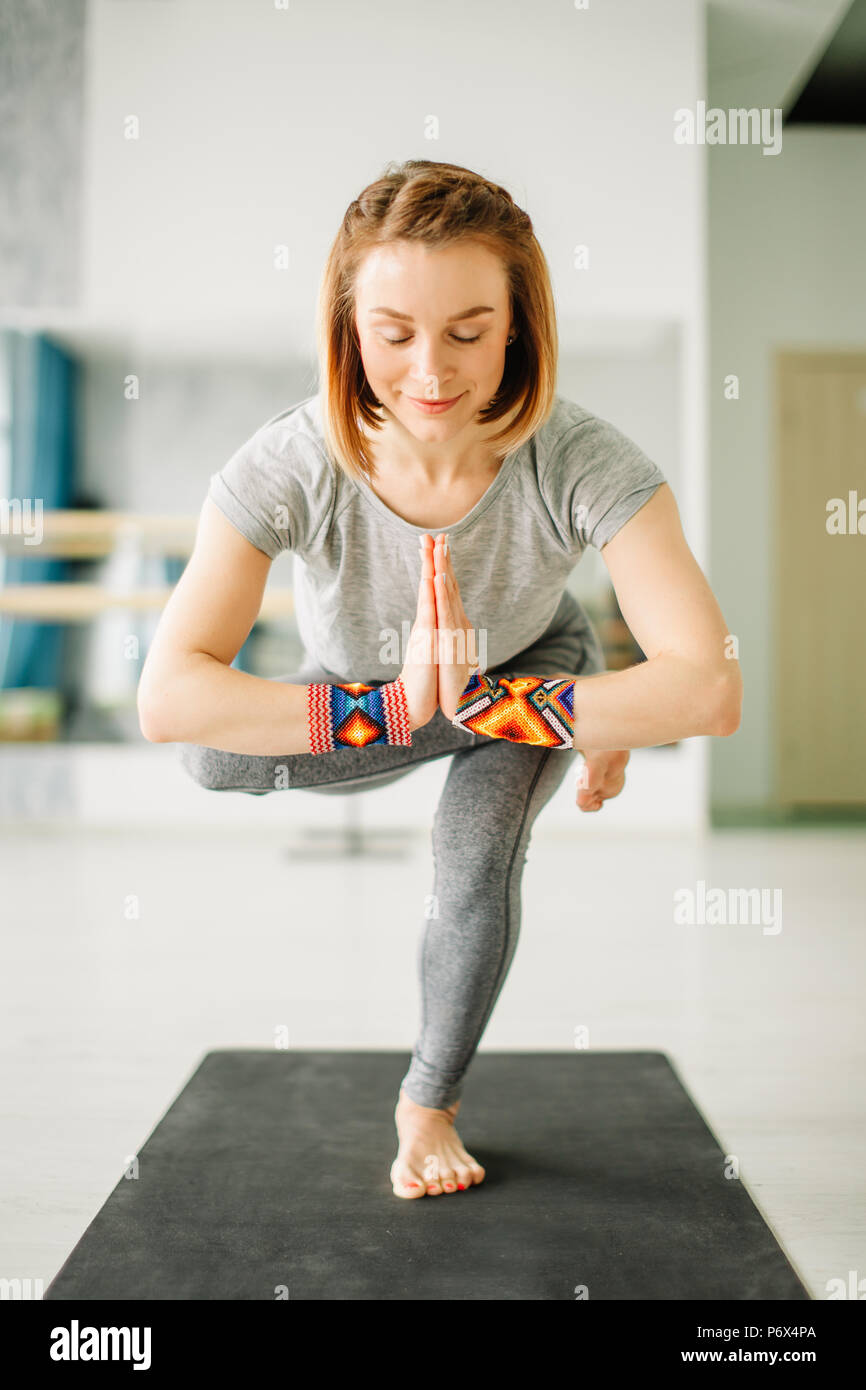 Close-up of charming young woman in a black suit doing sophisticated ...
