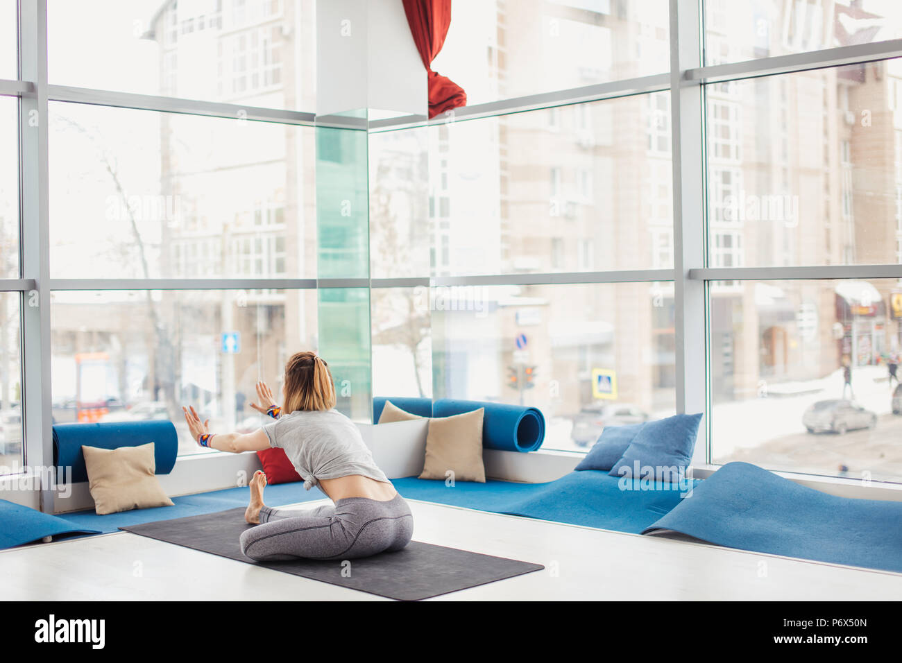 Rear view of training unrecognizable woman in transparent yoga class ...