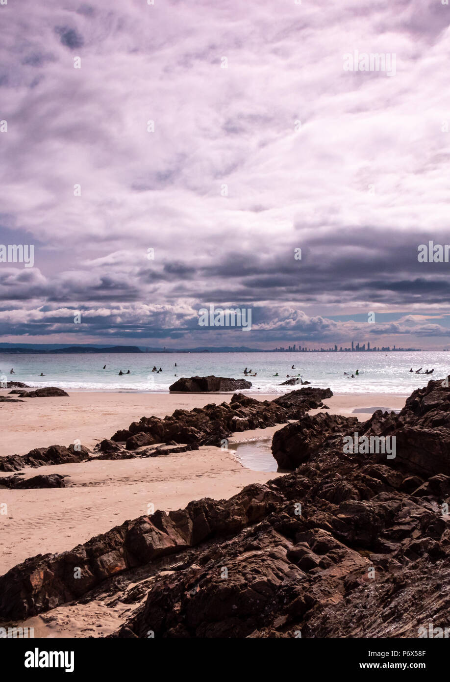Surf hitting the rocks on a beach Stock Photo - Alamy