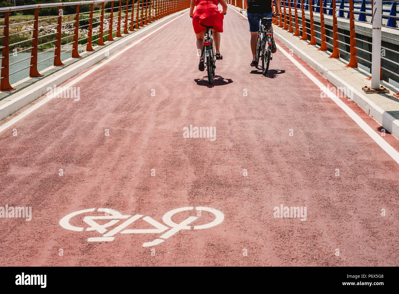 Bicycle lane with signal on the ground and cyclists passing over Stock ...