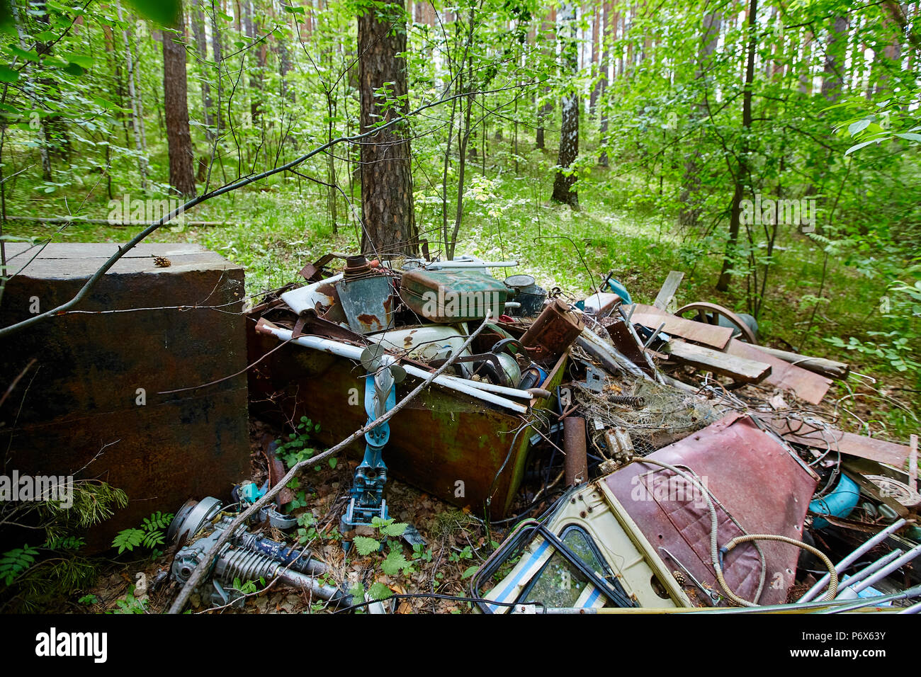 Dump old metal objects in the woods, rusty scrap metal. Environmental ...